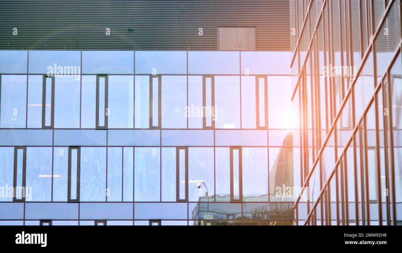Abstract closeup of the glass-clad facade of a modern building covered ...