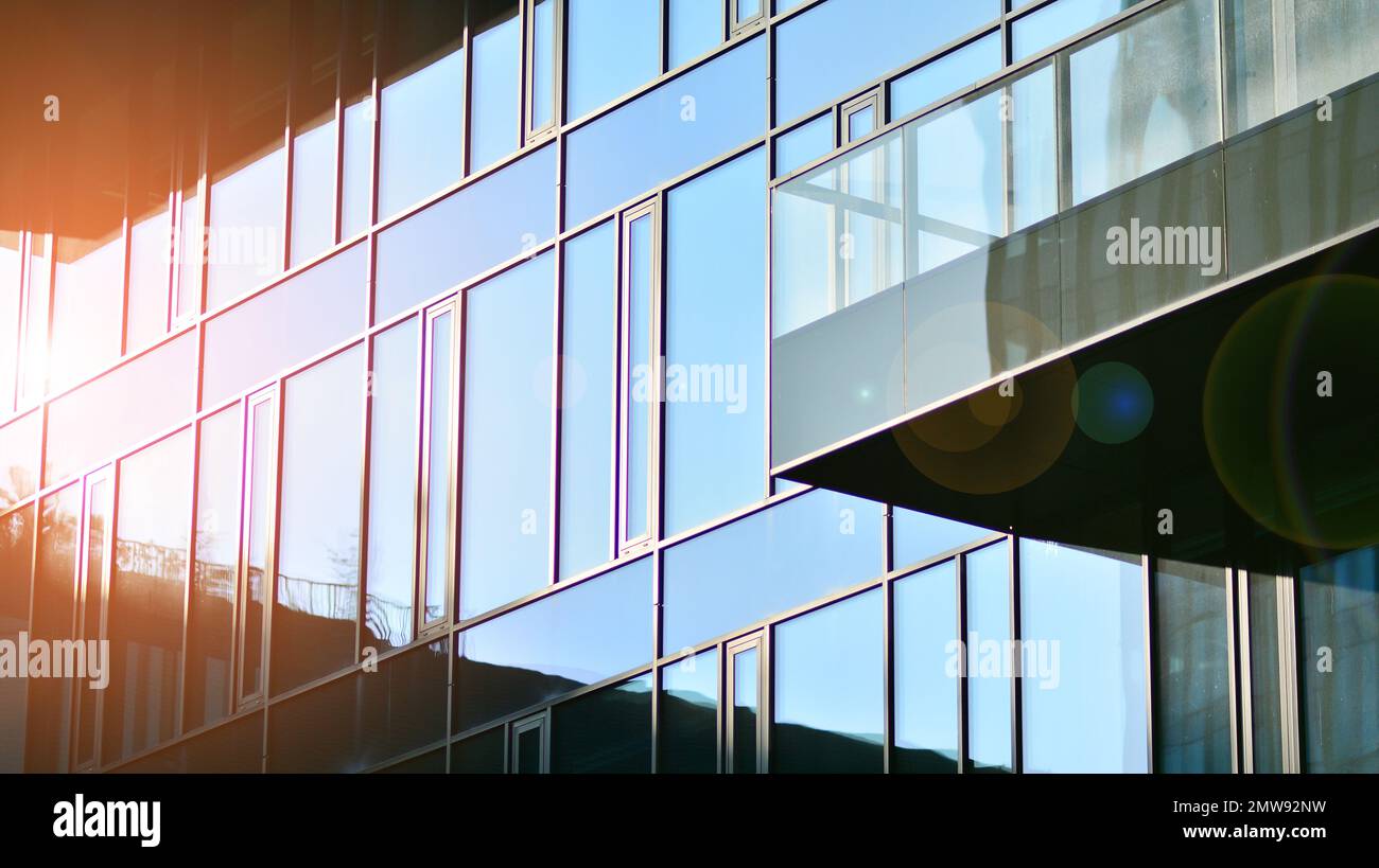 Abstract closeup of the glass-clad facade of a modern building covered ...