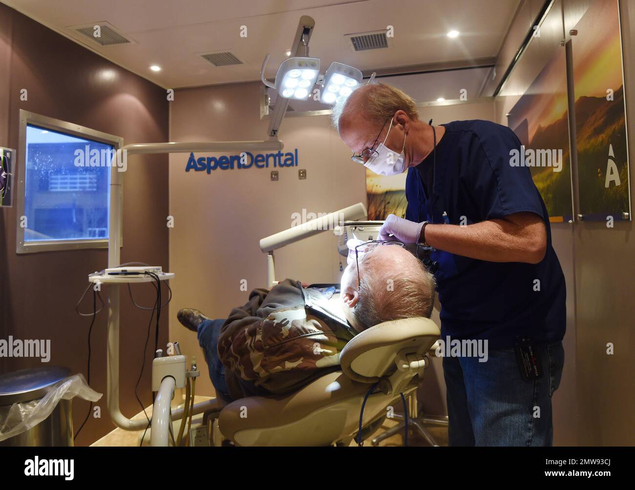IMAGE DISTRIBUTED FOR ASPEN DENTAL - Dr. Mike Rogers, right, performs ...