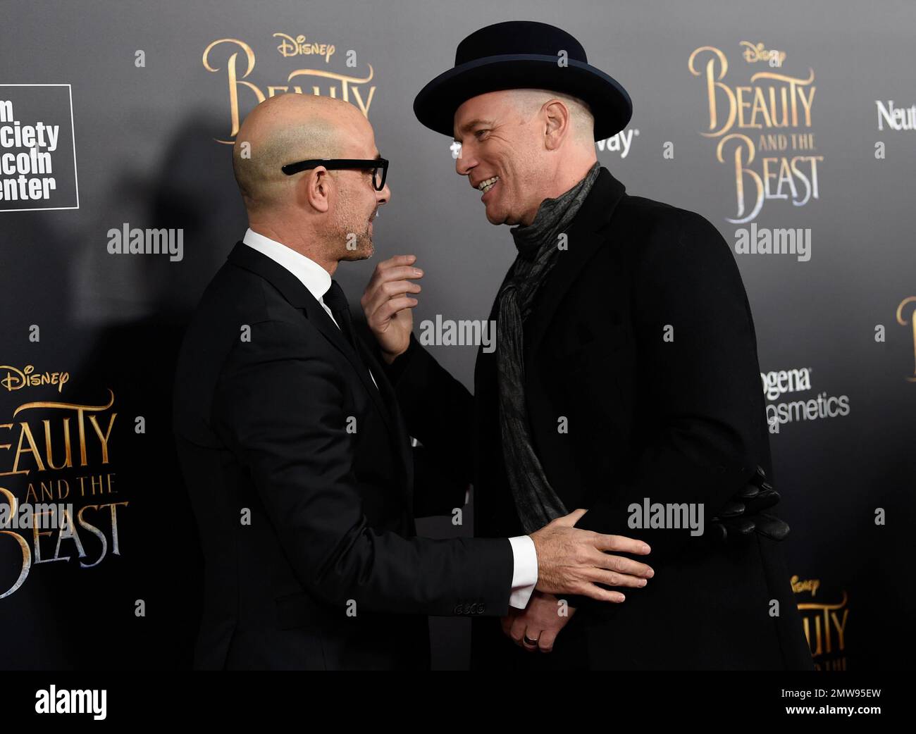 Actors Stanley Tucci, left, and Ewan McGregor greet each other at a ...