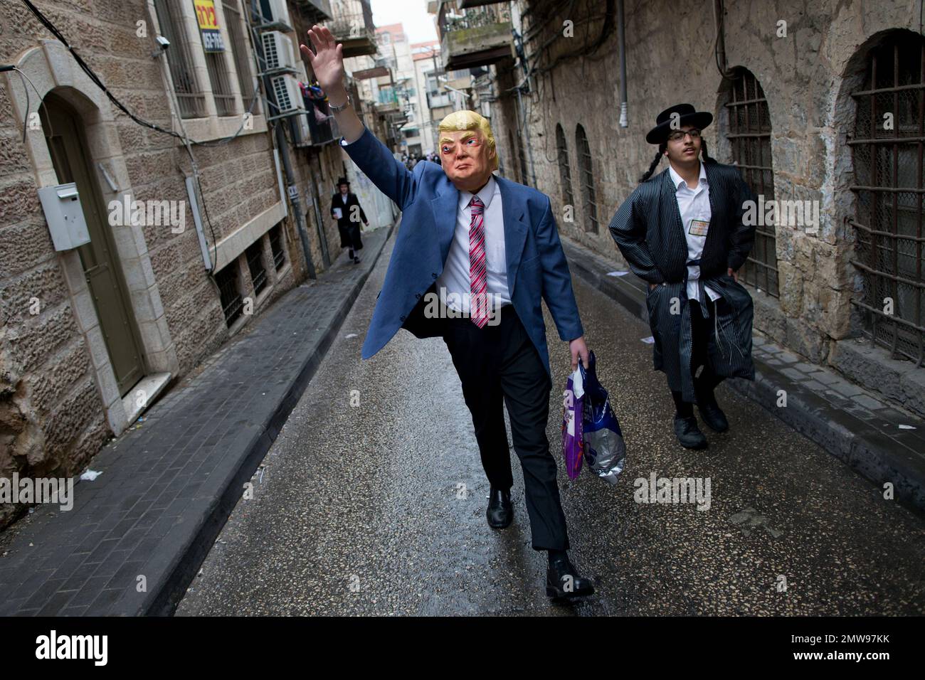 An ultra-Orthodox Jewish man wears U.S. President Donald Trump's mask ...