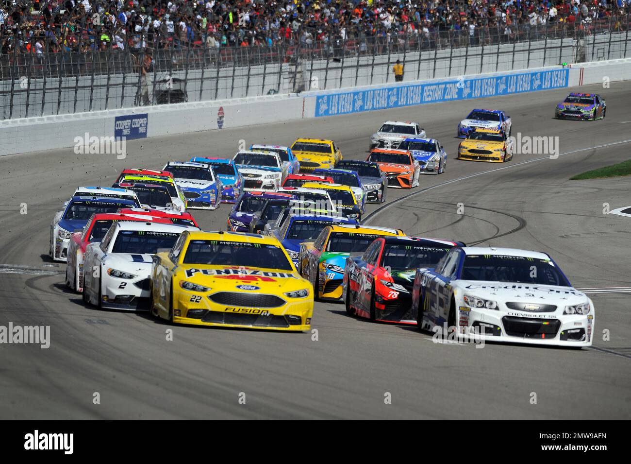 Joey Logano (22) and Jamie McMurray (1) lead the pack as they come out ...