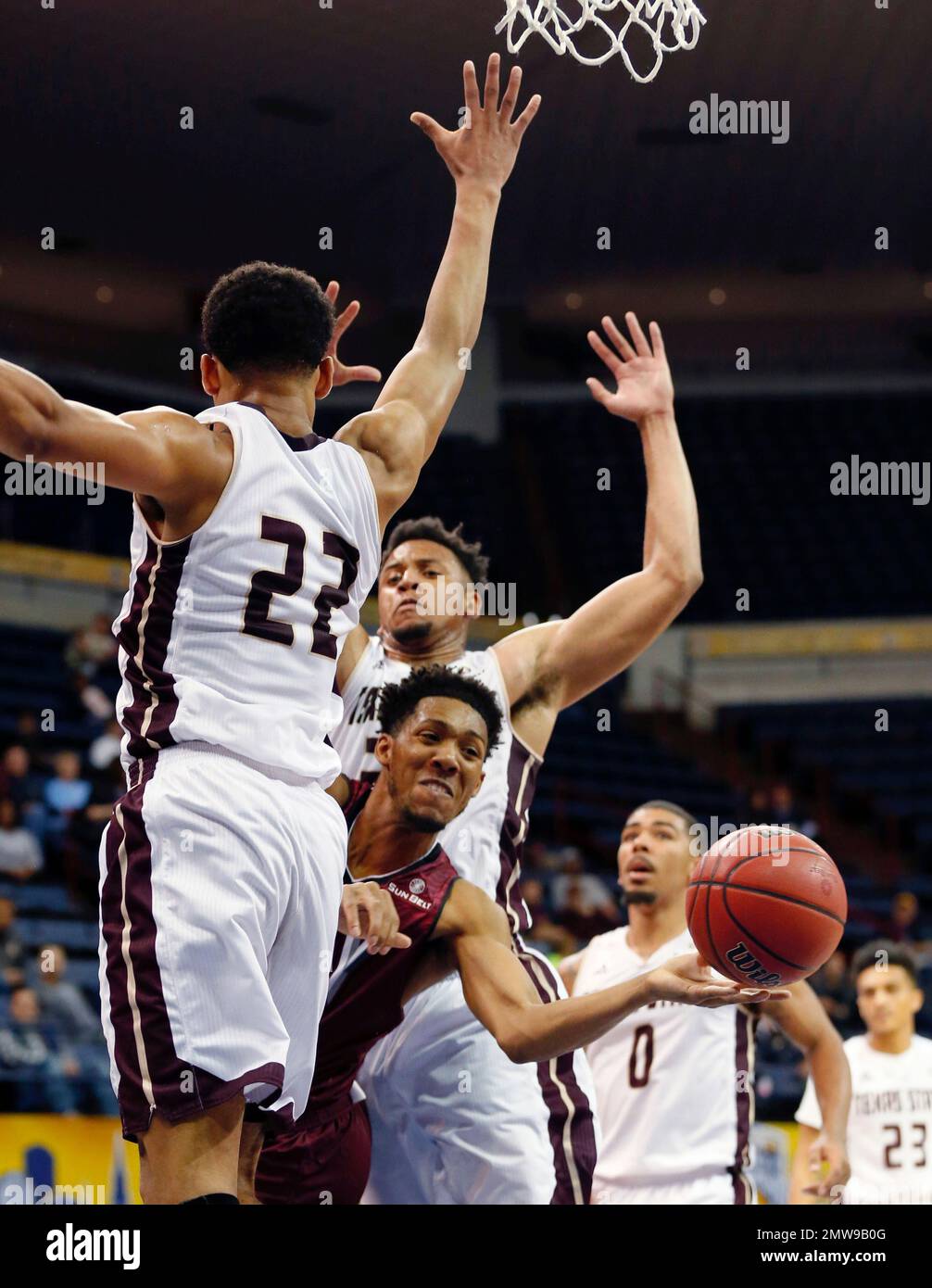 Troy guard Wesley Person (3) passes around Texas State guard Nijal ...
