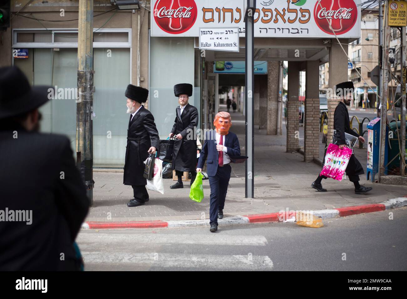 An Ultra-Orthodox Jewish child wears U.S. President Donald Trump's mask ...