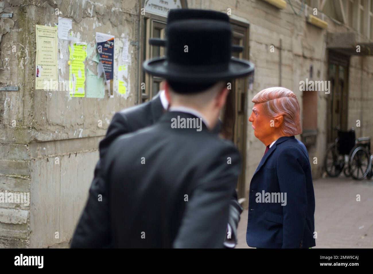 An Ultra-Orthodox Jewish child wears U.S. President Donald Trump's mask ...