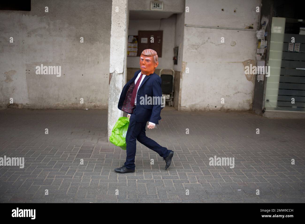 An Ultra-Orthodox Jewish child wears U.S. President Donald Trump's mask ...