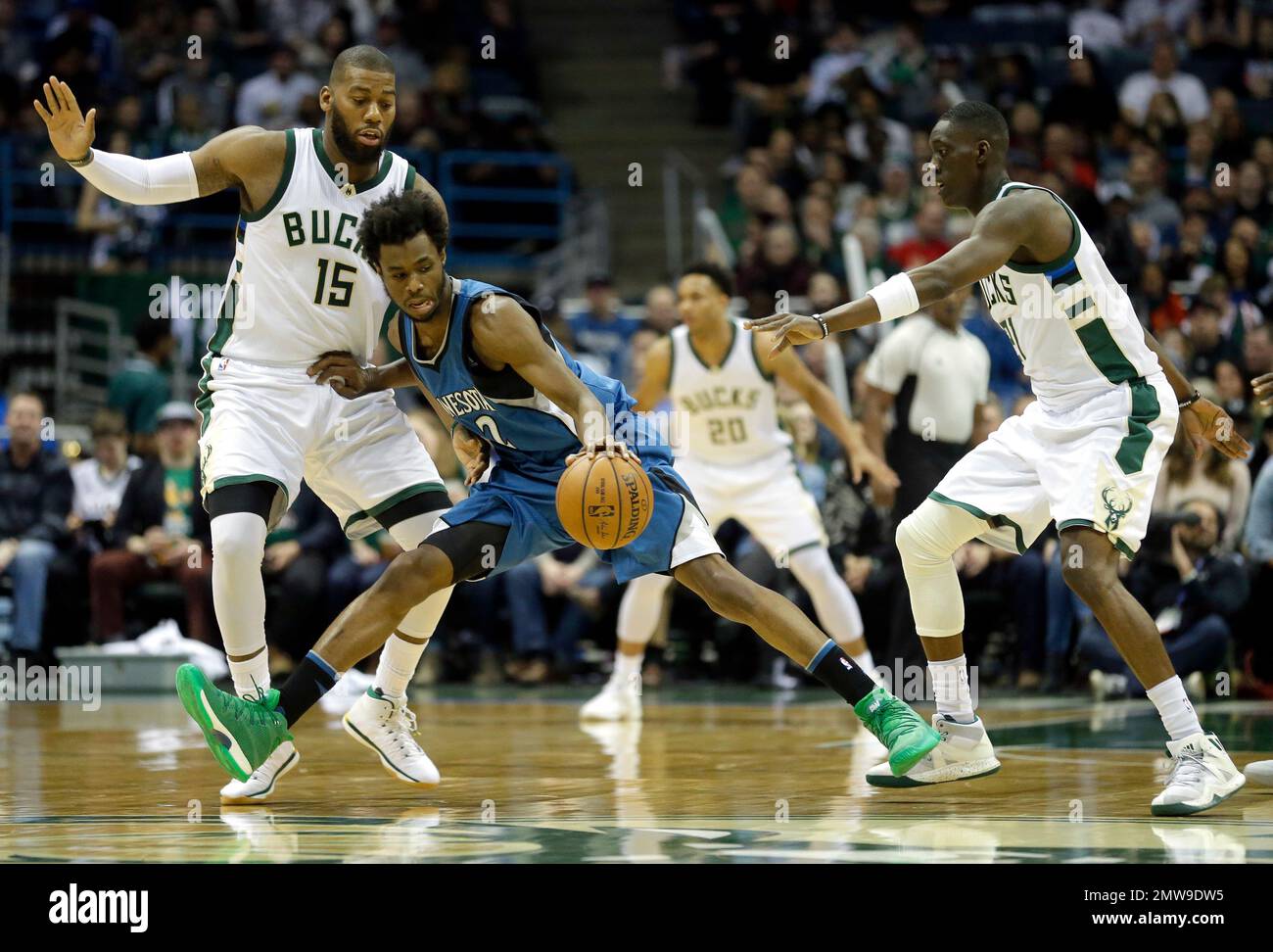 Minnesota Timberwolves' Andrew Wiggins, middle, dribbles between ...
