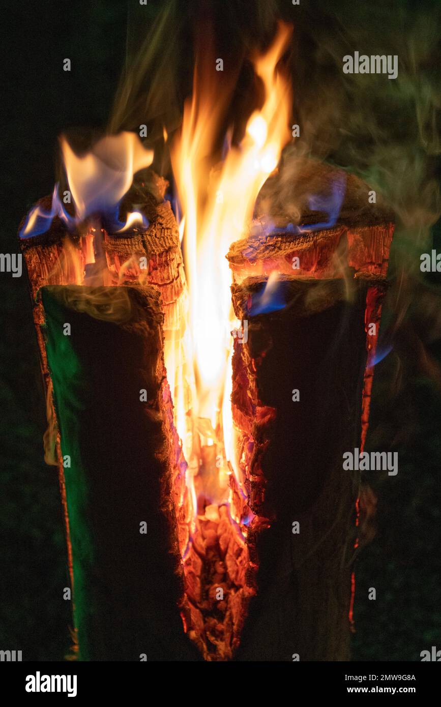 swedish fire in woodtrunk camp by night Stock Photo - Alamy