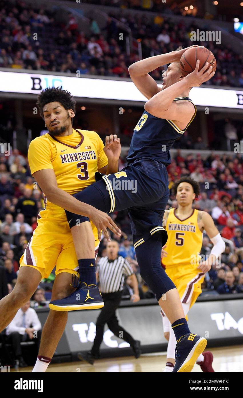 Minnesota forward Jordan Murphy (3) fouls Michigan forward Moritz ...