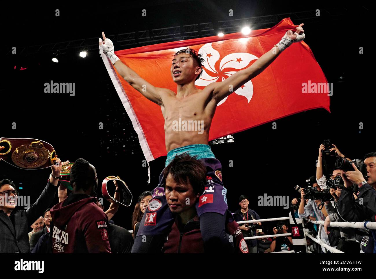 Hong Kong fighter Rex Tso raises a Hong Kong flag to celebrate after ...