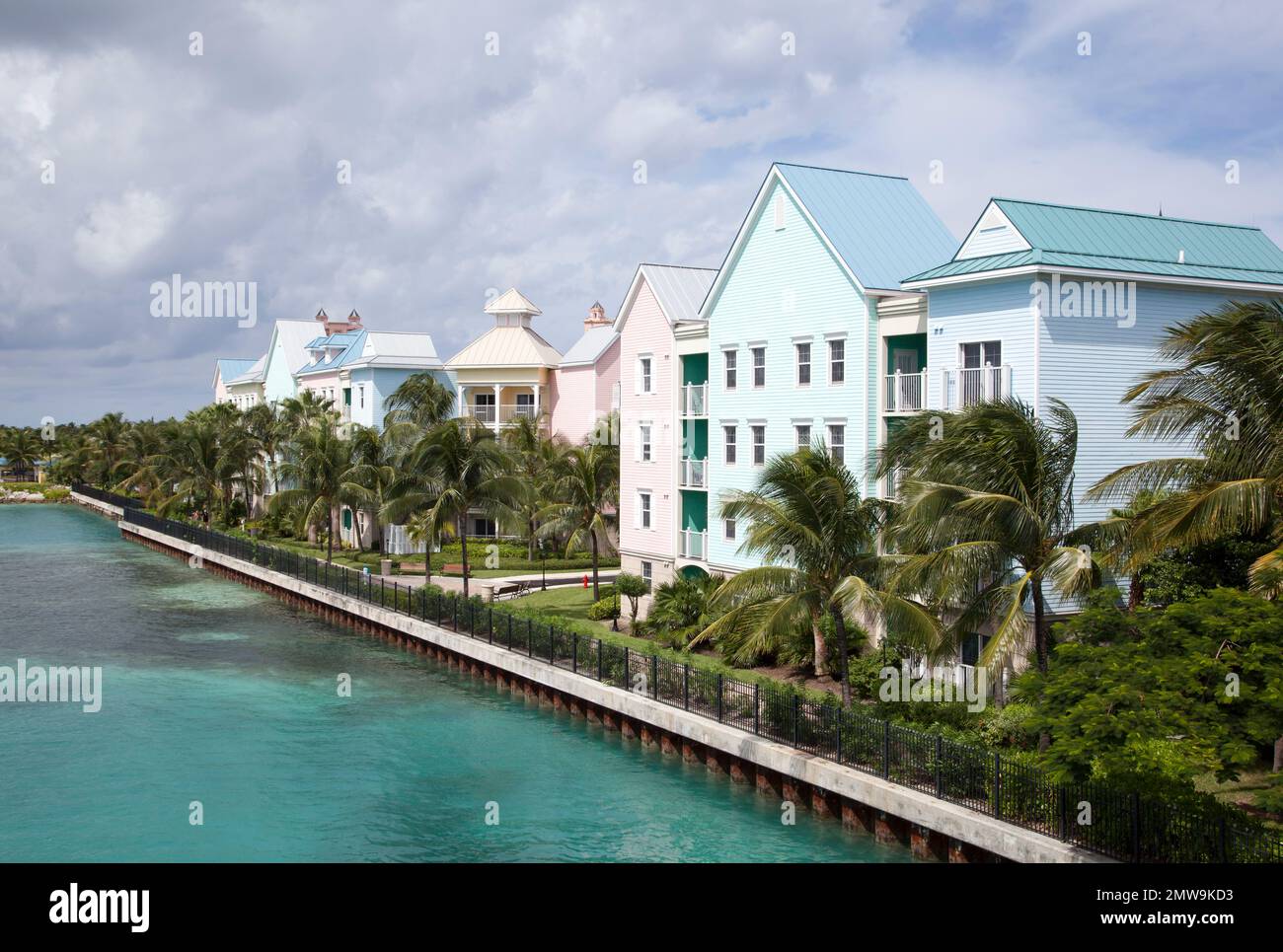 The view of colorful residential buildings surrounded by palm trees on ...