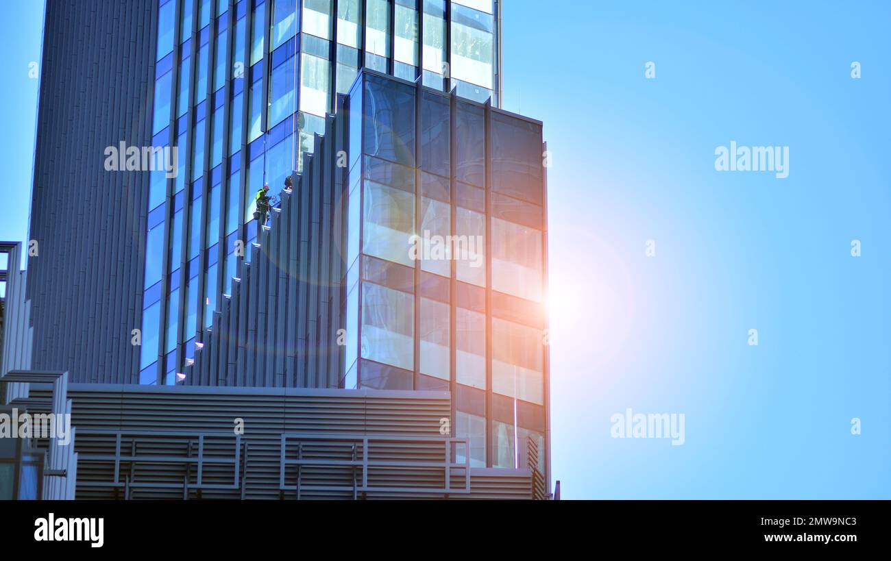 Abstract closeup of the glass-clad facade of a modern building covered ...
