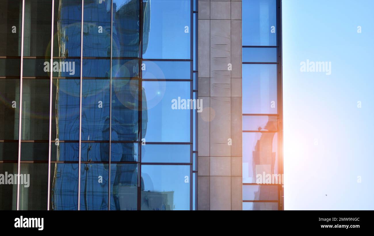 Abstract closeup of the glass-clad facade of a modern building covered ...
