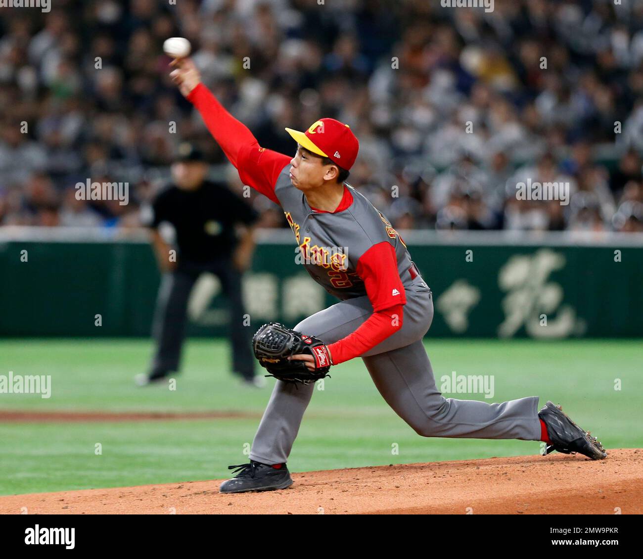 China’s starter Gan Quan delivers a pitch against Japan during the ...