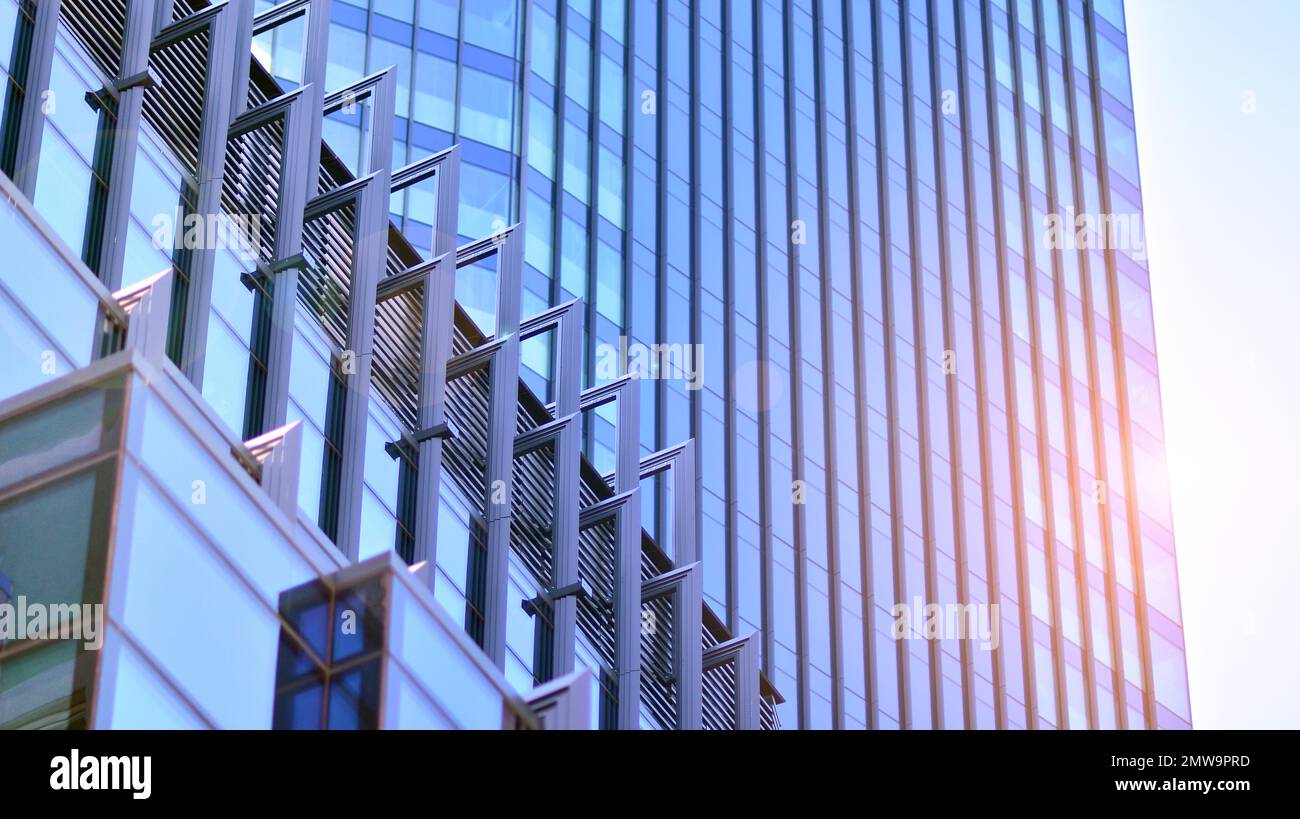 Abstract closeup of the glass-clad facade of a modern building covered ...