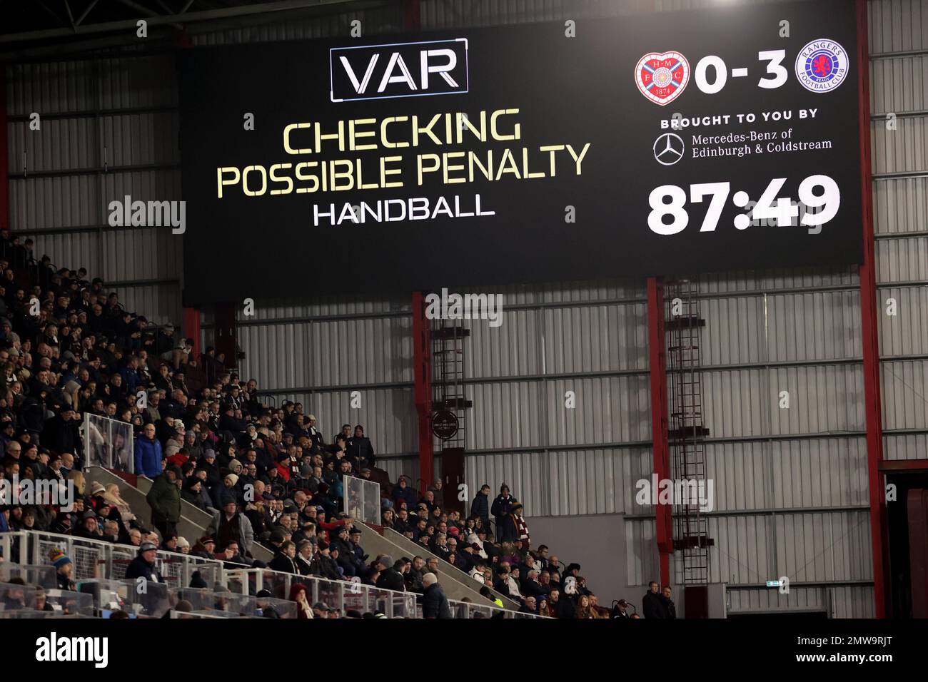 A VAR check for a possible handball is displayed on a big screen during ...