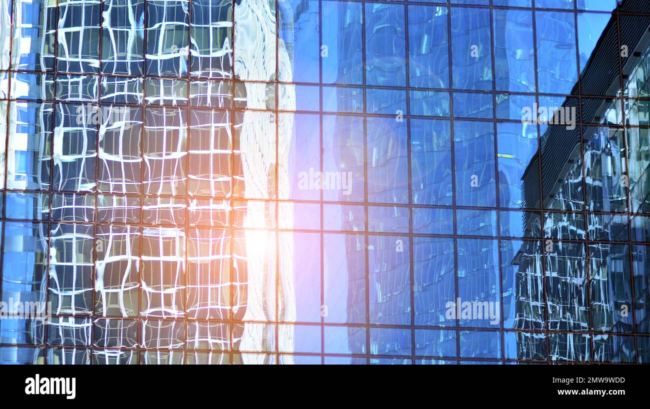 Abstract closeup of the glass-clad facade of a modern building covered ...