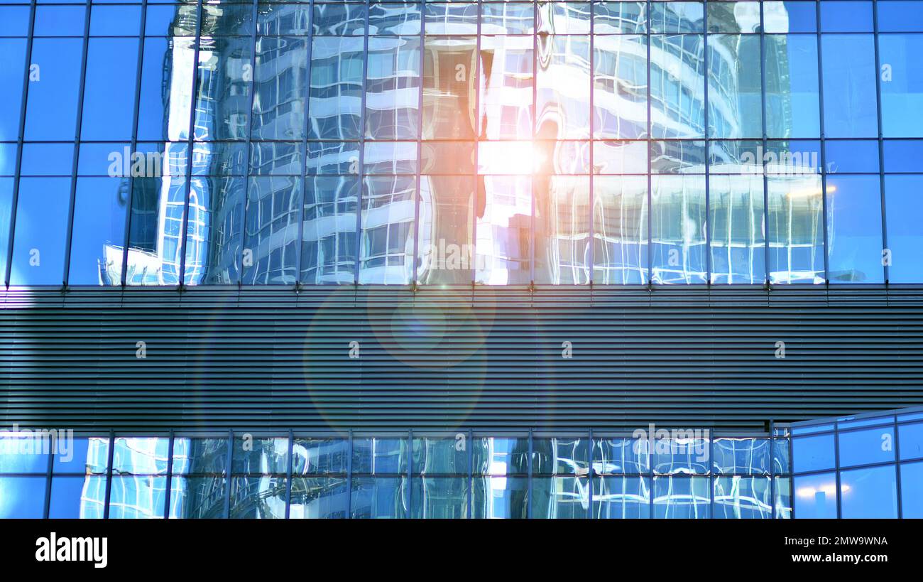 Abstract closeup of the glass-clad facade of a modern building covered ...