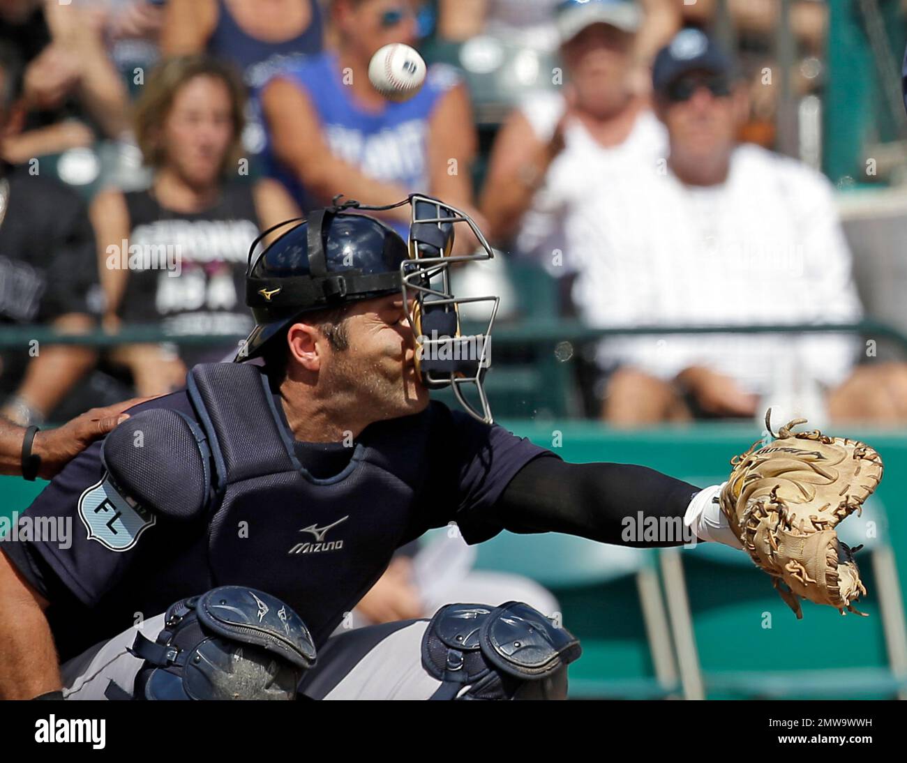 A foul ball bounces off the face mask of New York Yankees catcher ...
