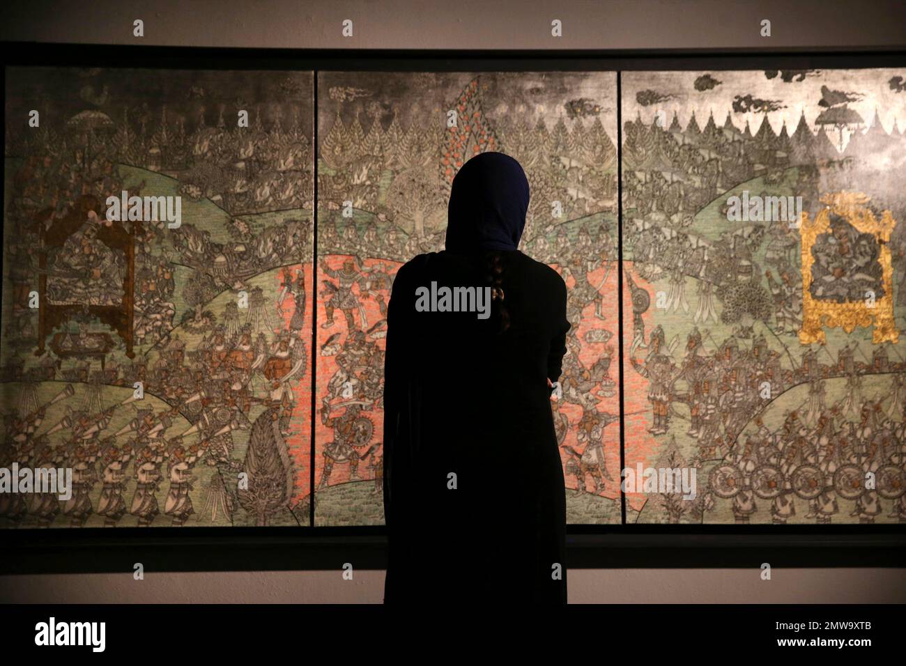 An Iranian woman looks at a painting "Piano War" from "Unwritten ...