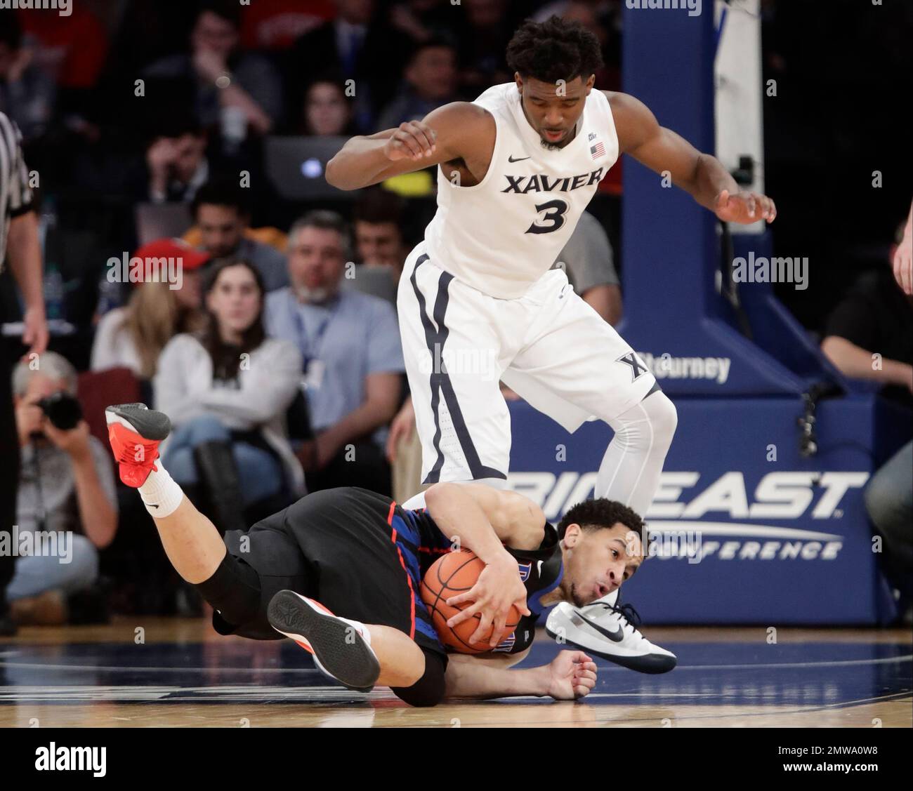 Xavier's Quentin Goodin (3) watches as DePaul's Billy Garrett Jr. (5 ...