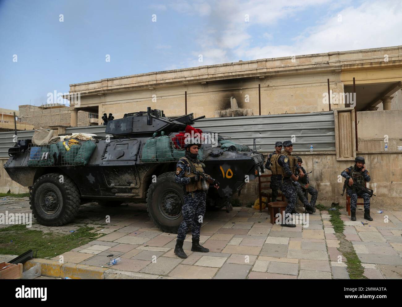 Iraqi federal police stand guard outside Mosul's heavily damaged museum ...