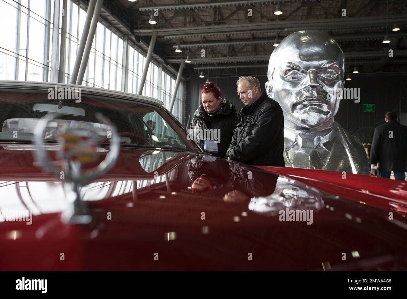 A couple look at a Cadillac Eldorado car released in1967, in front of a ...