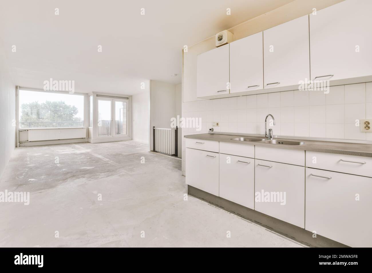 an empty kitchen with all white cabinets and appliances on the counter ...