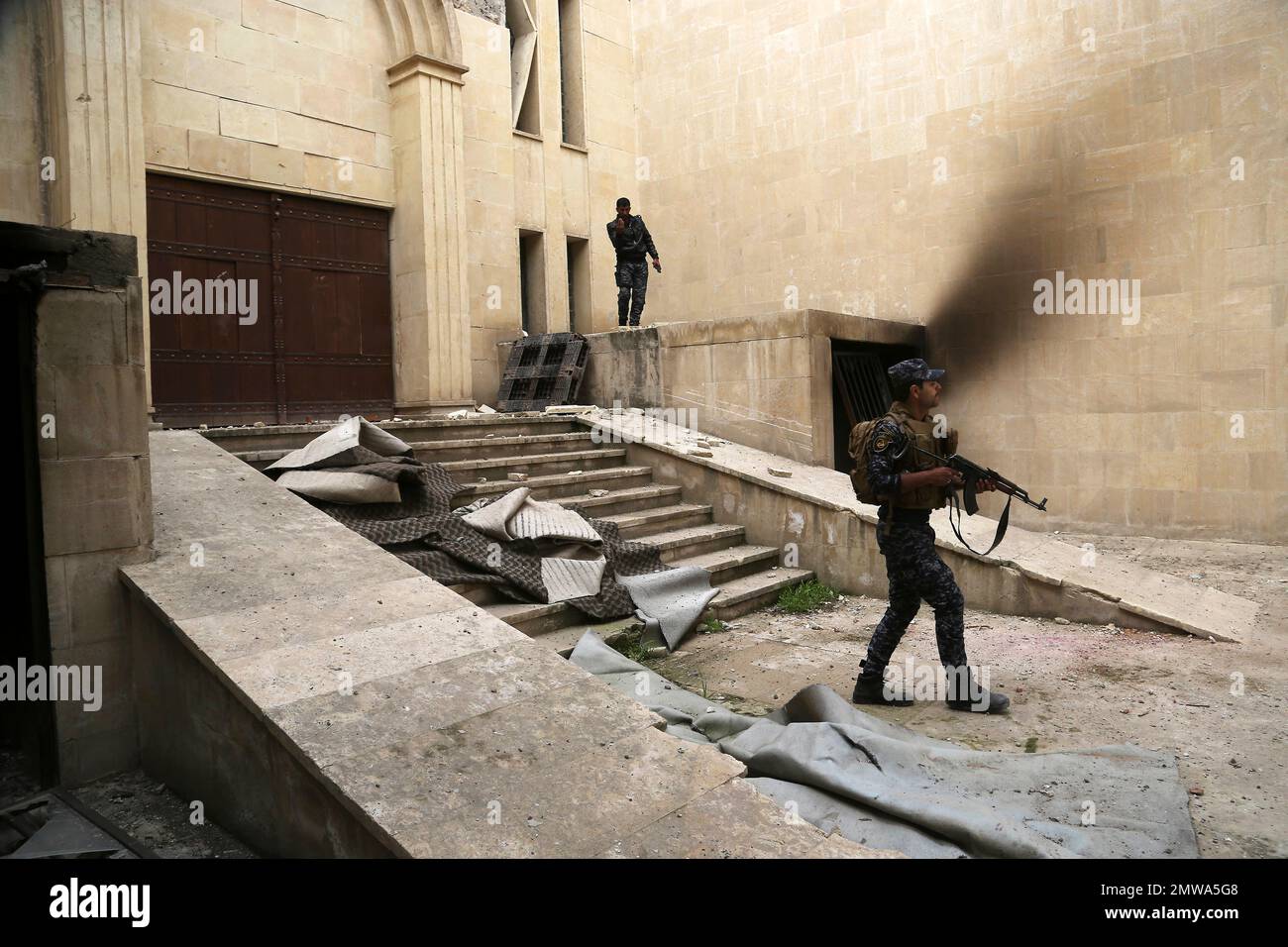 Iraqi federal police inspect Mosul's heavily damaged museum. Most of ...