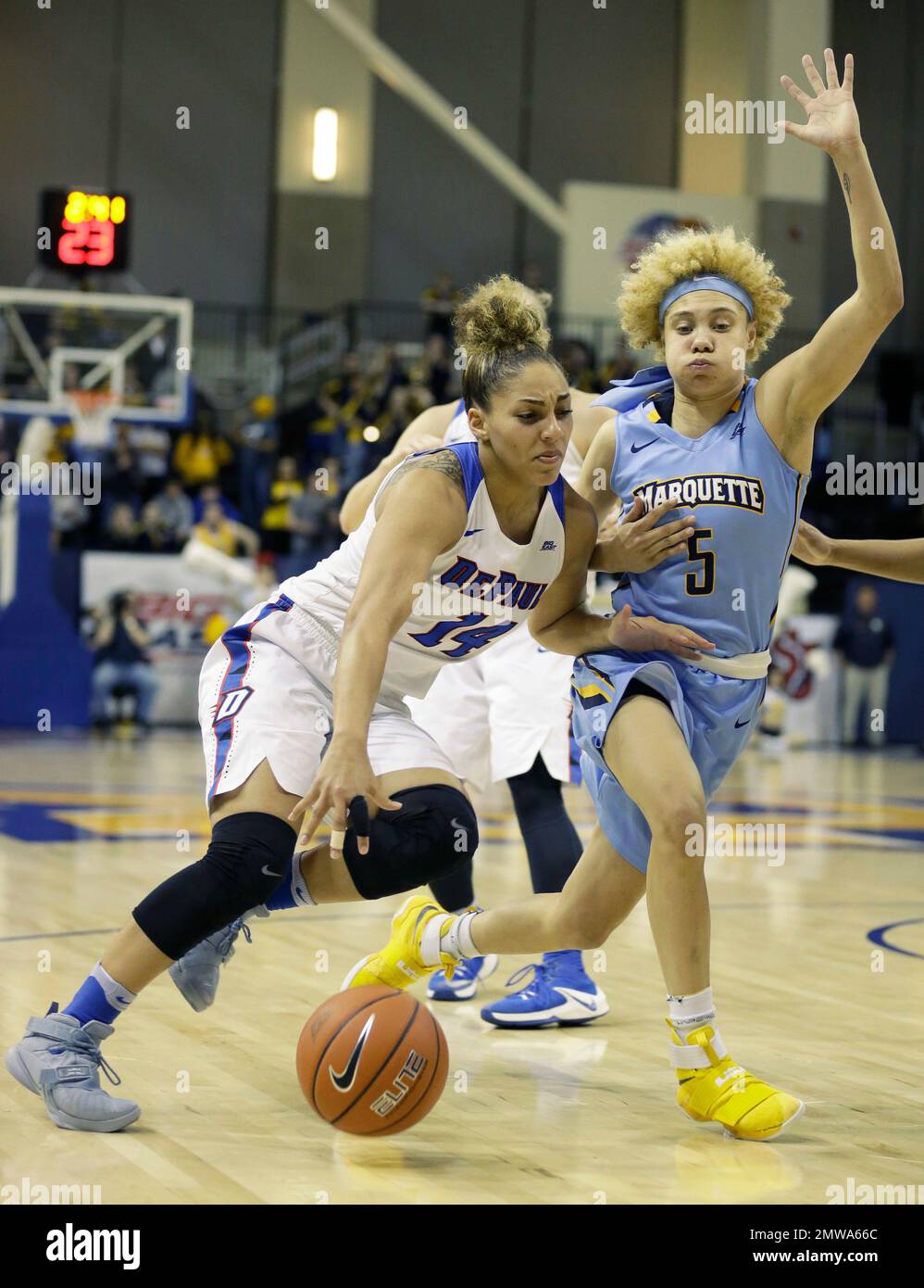 DePaul's Jessica January, left, drives against Marquette's Natisha ...