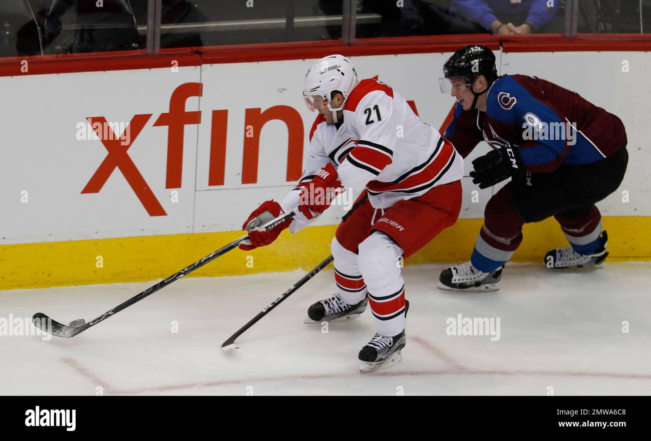 Carolina Hurricanes right wing Lee Stempniak, left, picks up a loose puck in front of Colorado ...