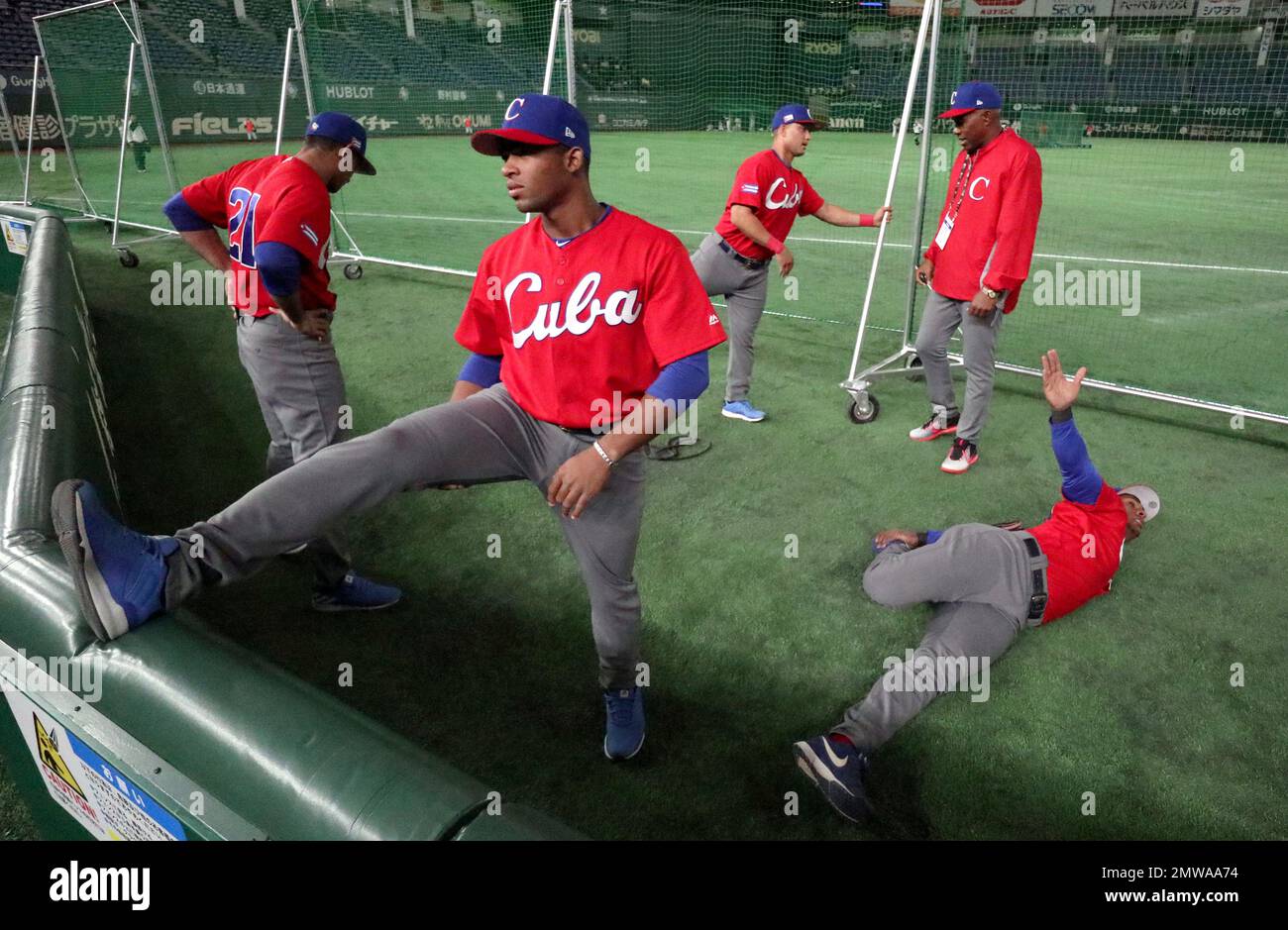Cuba's Yoelkis Cespedes, center, and Yurisbel Gracial, lying on the ...