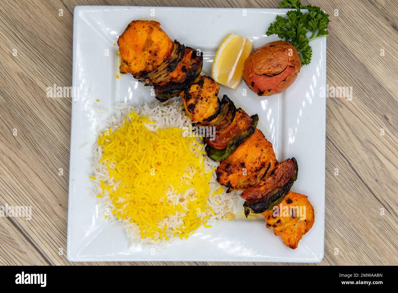 Overhead view of generous skewer of chicken shish kabob, grilled to ...