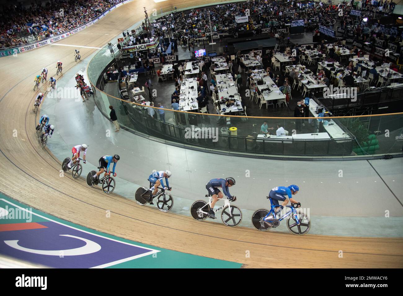 Cyclists chase each other around the track during the men's points race ...