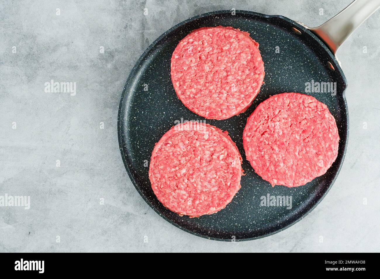 Burger patties close-up. Fresh raw burger patties close-up on a frying ...