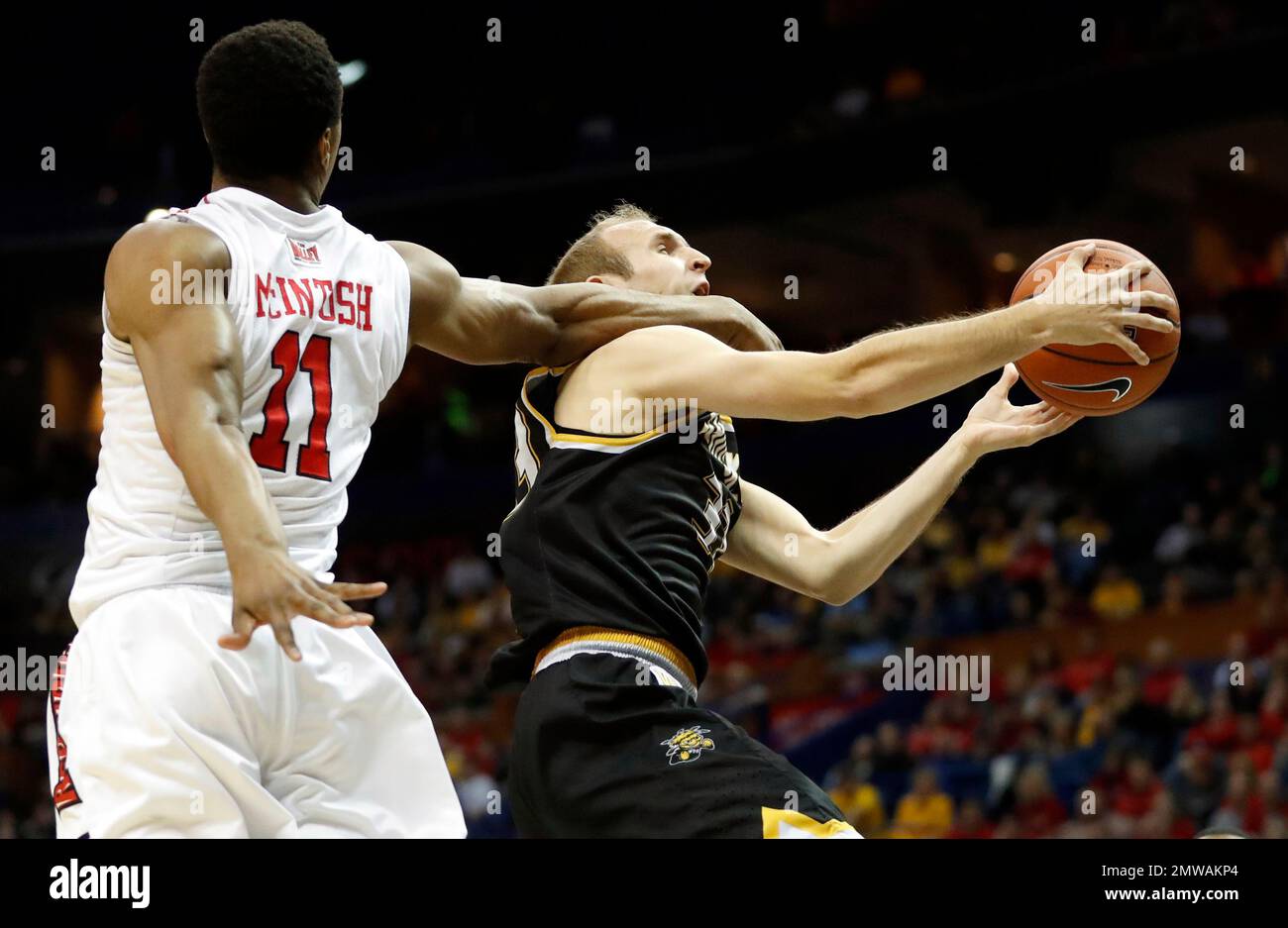 Wichita State's Conner Frankamp, right, heads to the basket as Illinois ...