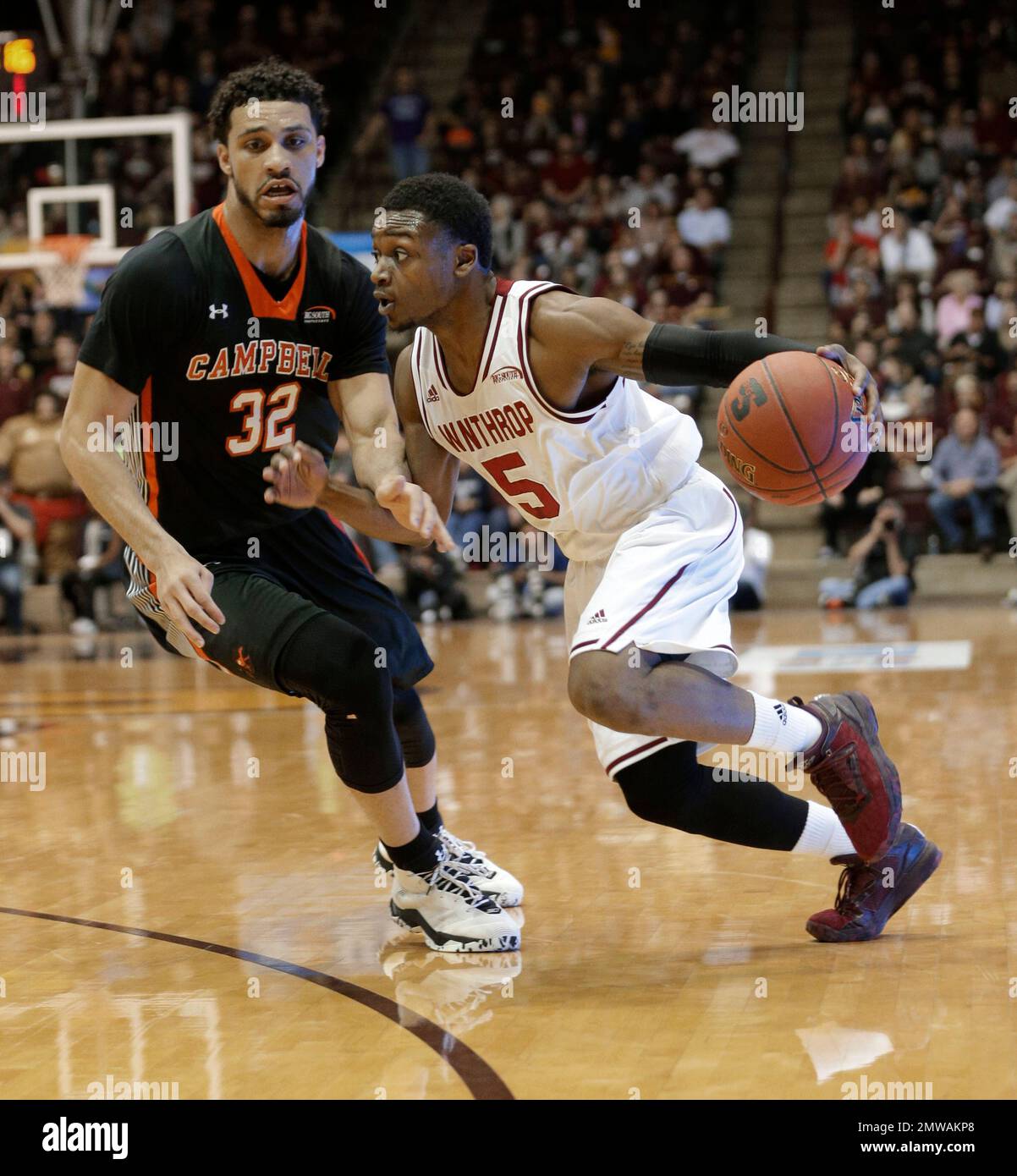 Winthrop's Keon Johnson (5) drives against Campbell's Shane Whitfield ...