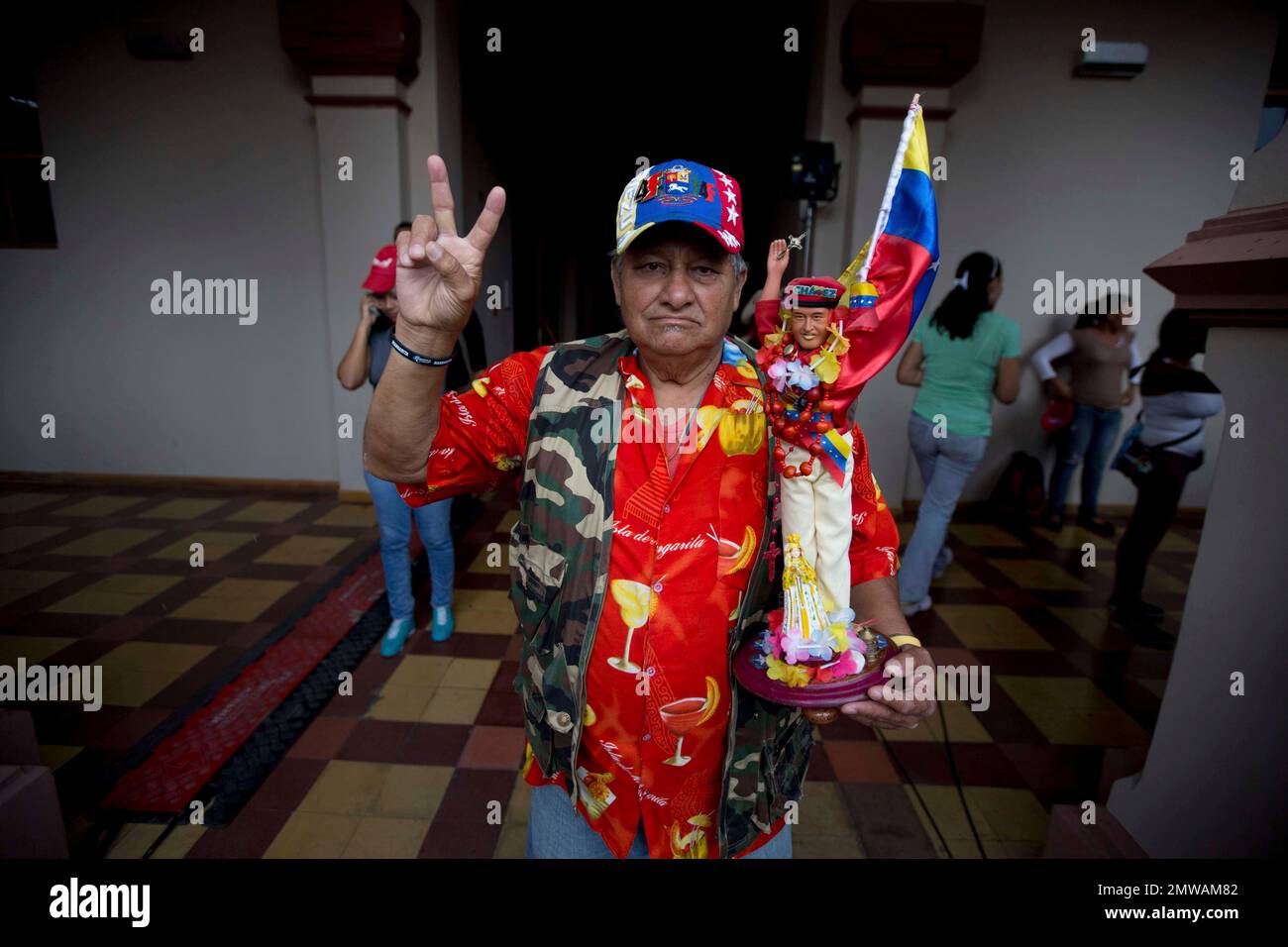 A supporter of Venezuela's late President Hugo Chavez poses for a photo ...