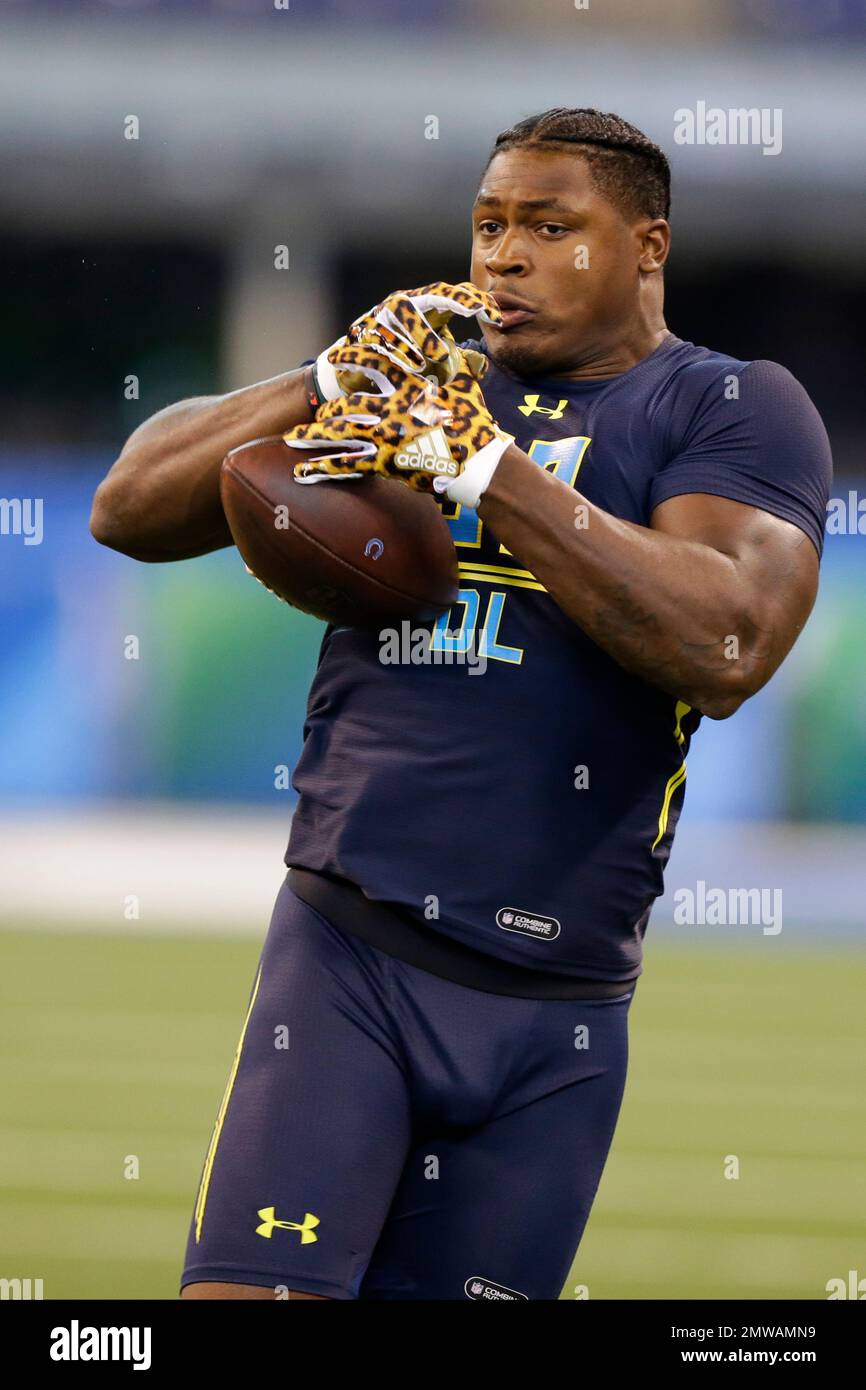 Miami defensive end Al-Quadin Muhammad runs a drill at the NFL football ...