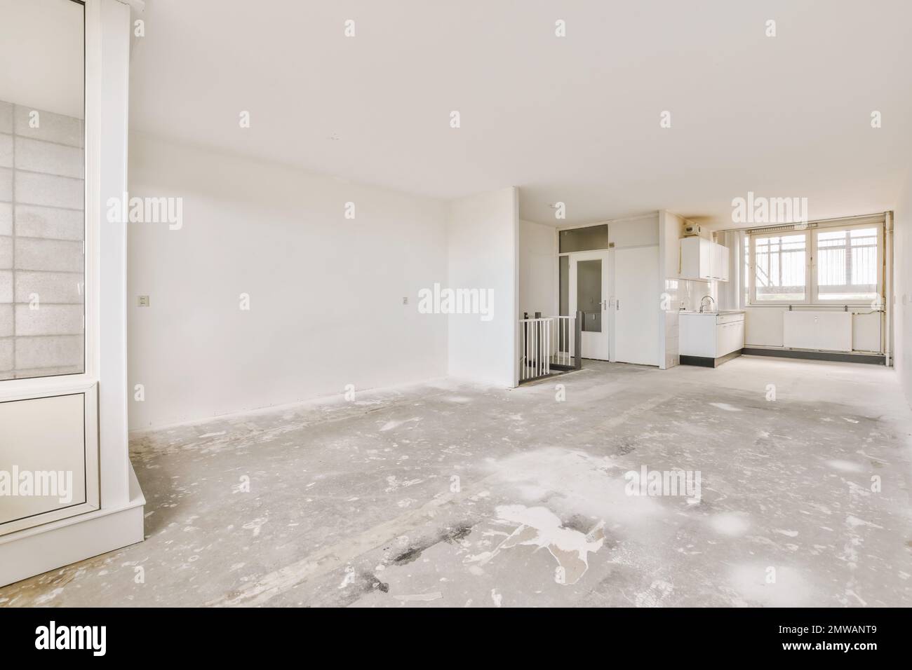 an empty living room with white walls and no one person standing in the ...