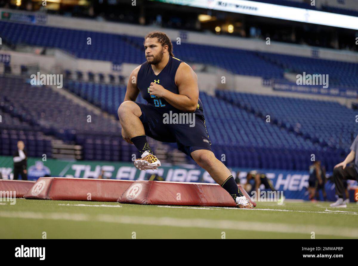 Washington defensive lineman Elijah Qualls runs a drill at the NFL ...