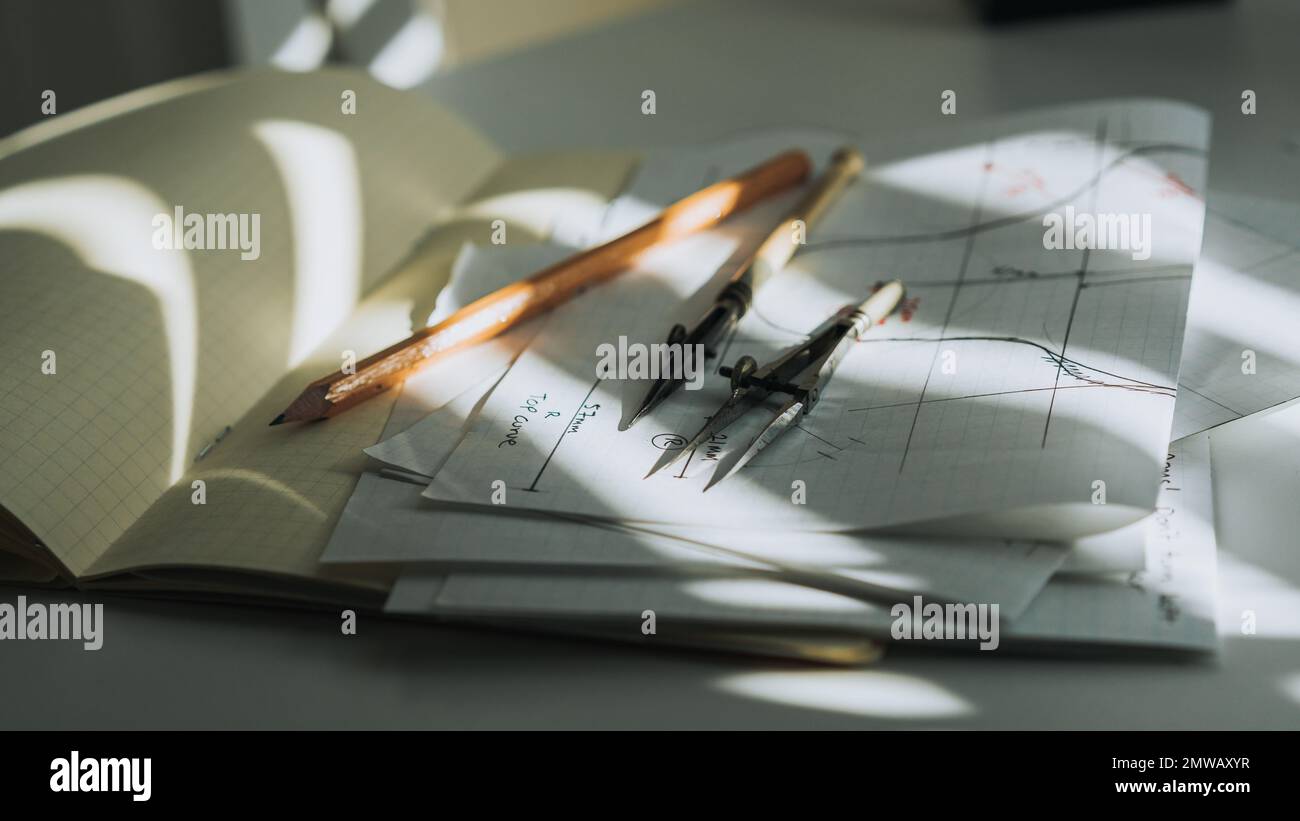 A Vintage drawing tools laying on a stack of paper Stock Photo - Alamy