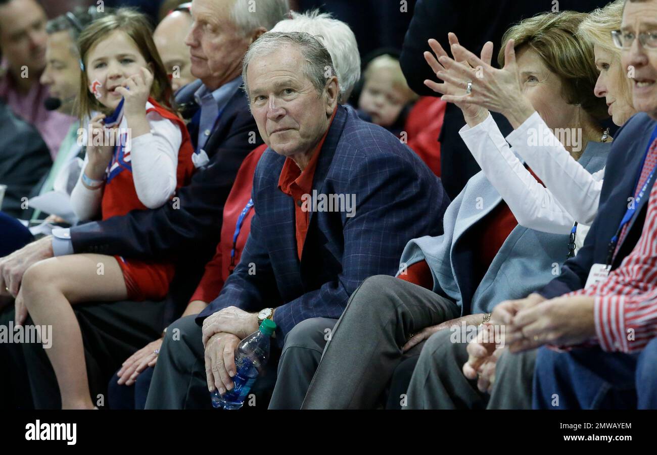 Former President George W Bush sits on the sidelines during an NCAA ...