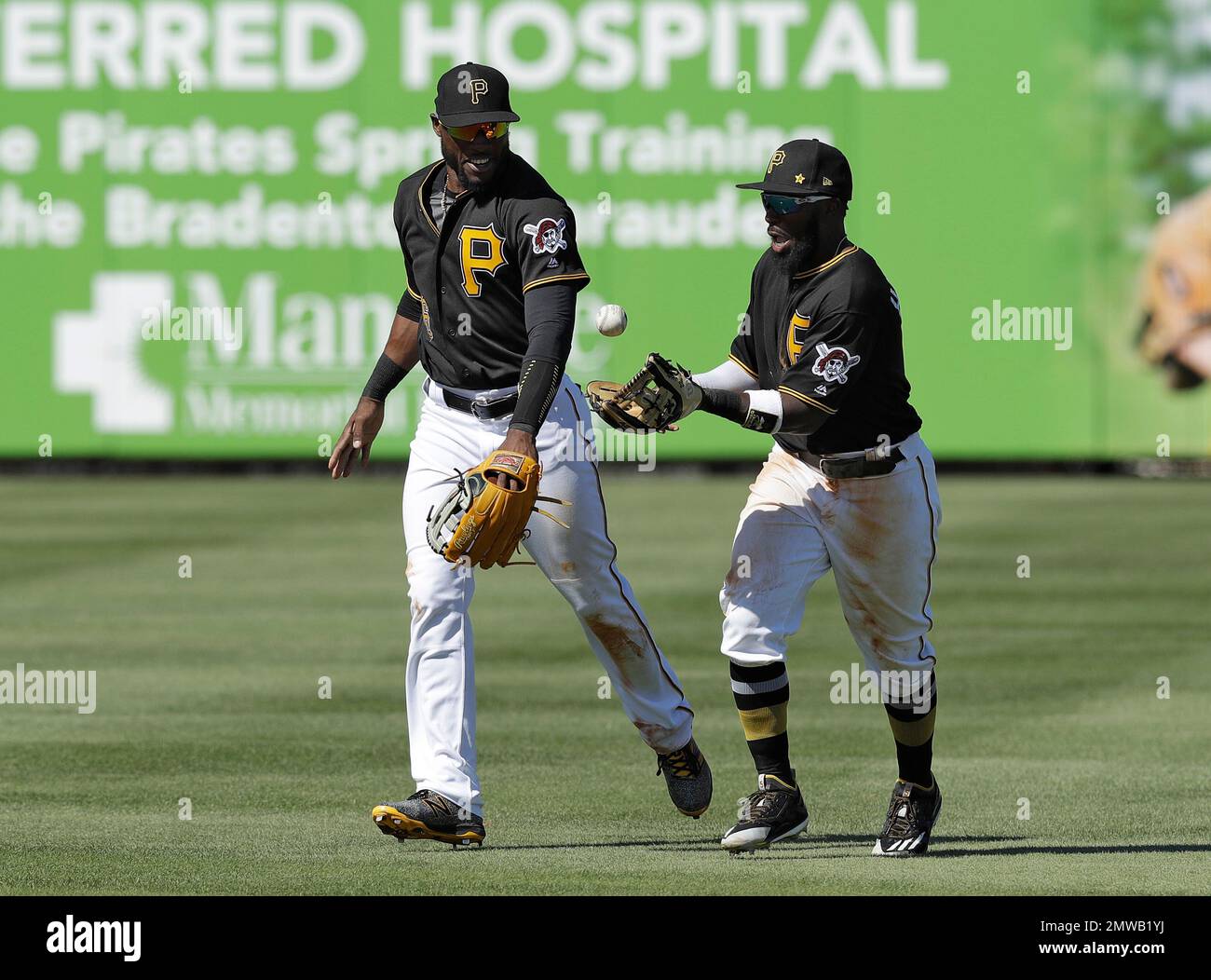 Pittsburgh Pirates center fielder Starling Marte, left, flips the ball ...