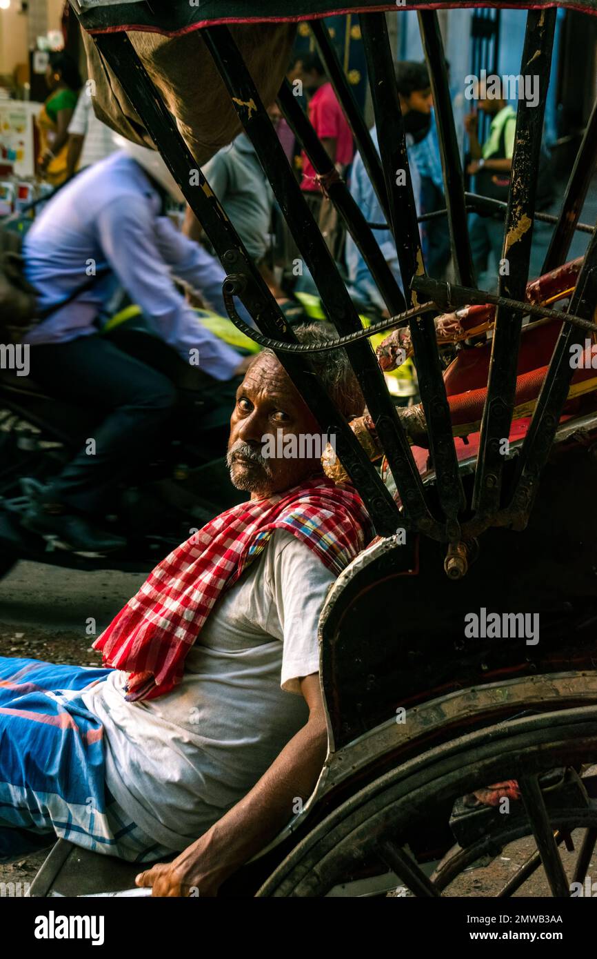A Rickshaw Wala relaxing and staring into camera Stock Photo - Alamy