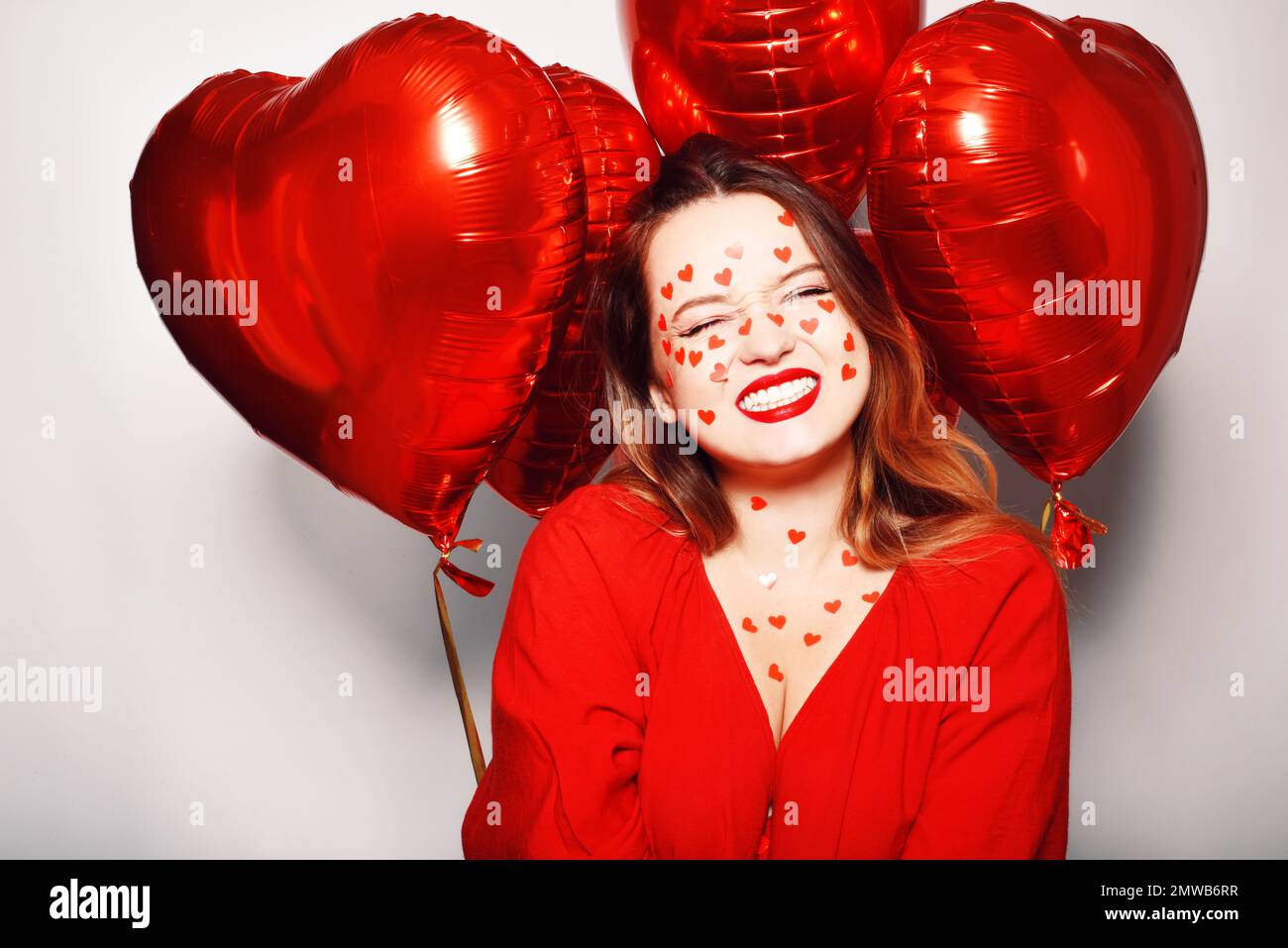 Beautiful woman with heart stickers on her face. Girl on a white ...