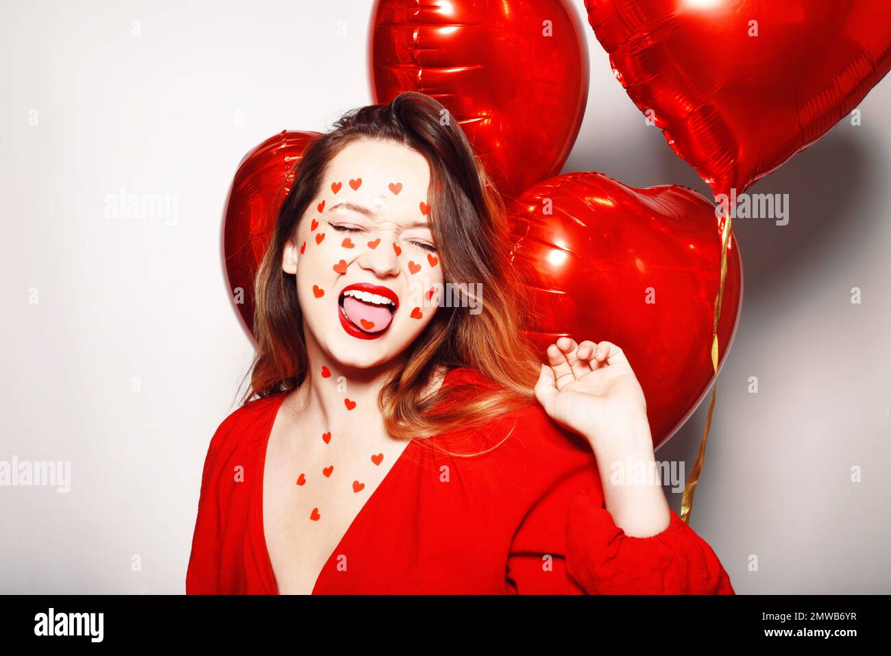 Beautiful woman with heart stickers on her face. Girl on a white ...