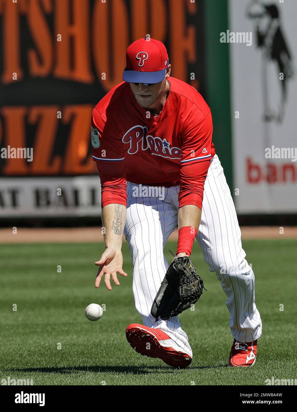 Philadelphia Phillies right fielder Michael Saunders reaches down to ...