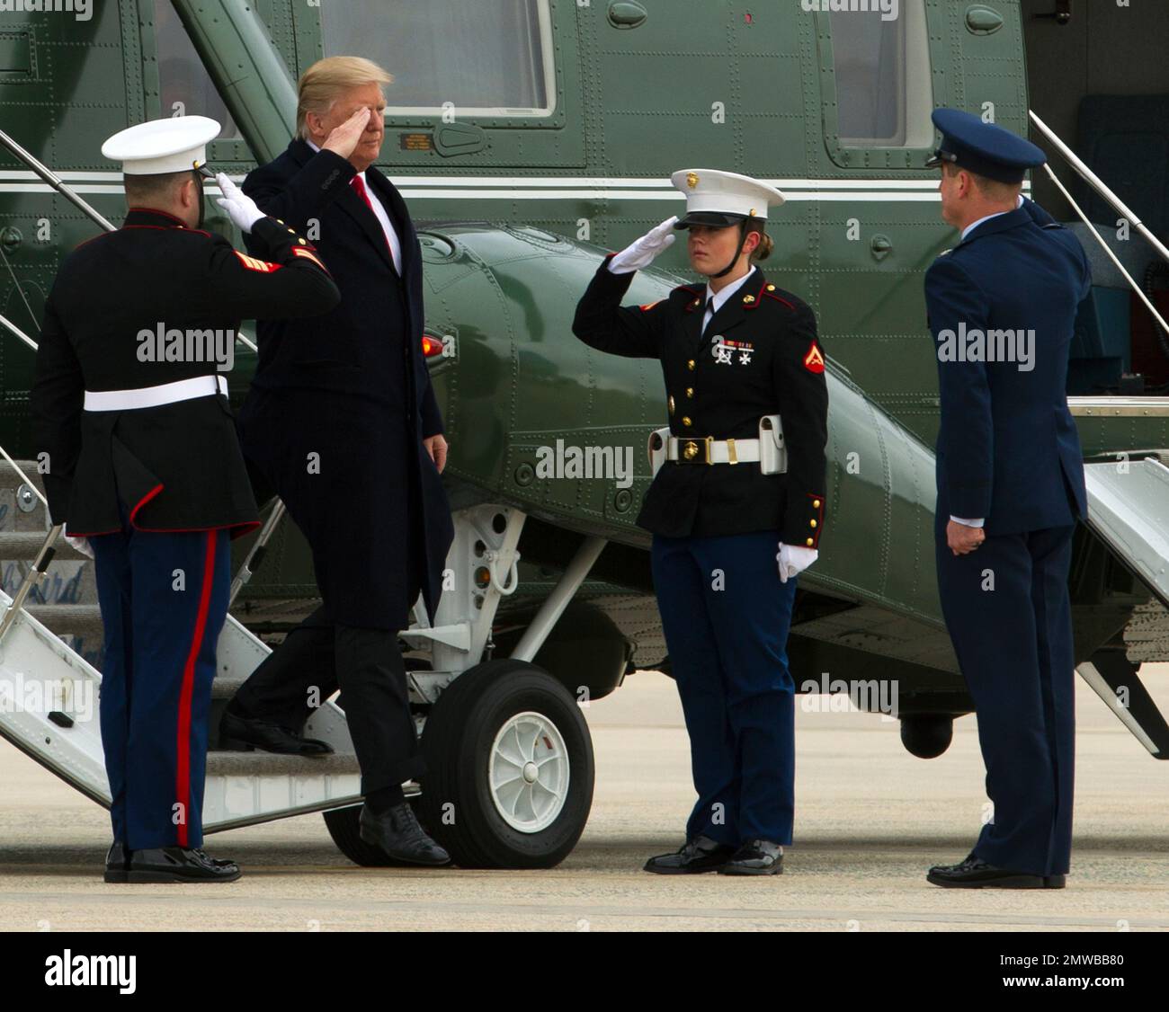 President Donald Trump salutes as he steps off from Marine One before ...