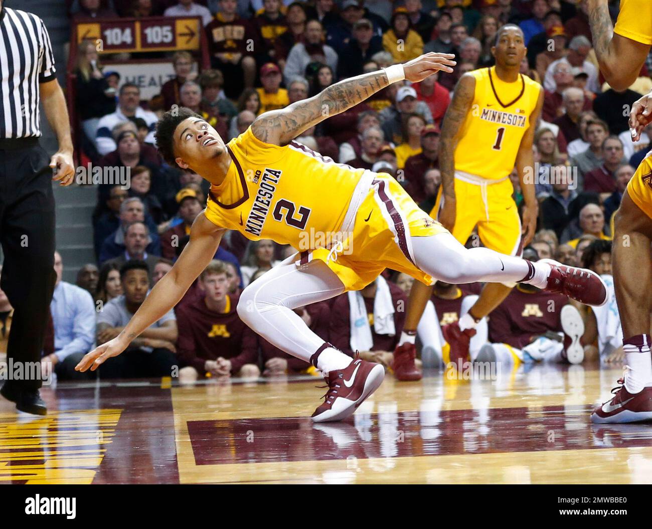 Minnesota's Nate Mason (2) falls after being fouled in play against ...